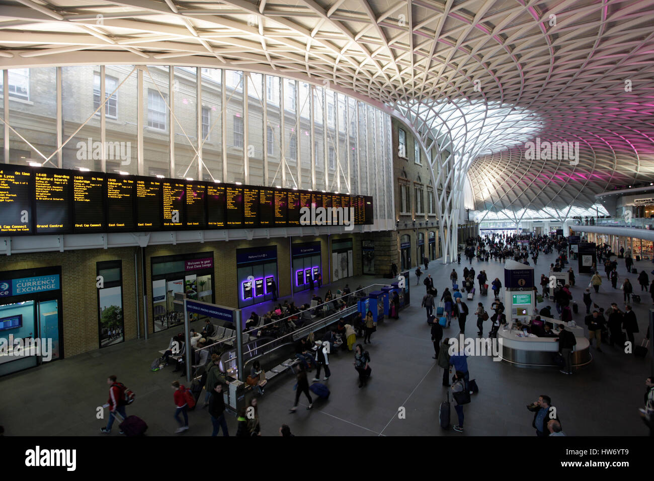 People on the concourse and departure boards; inside Kings Cross ...