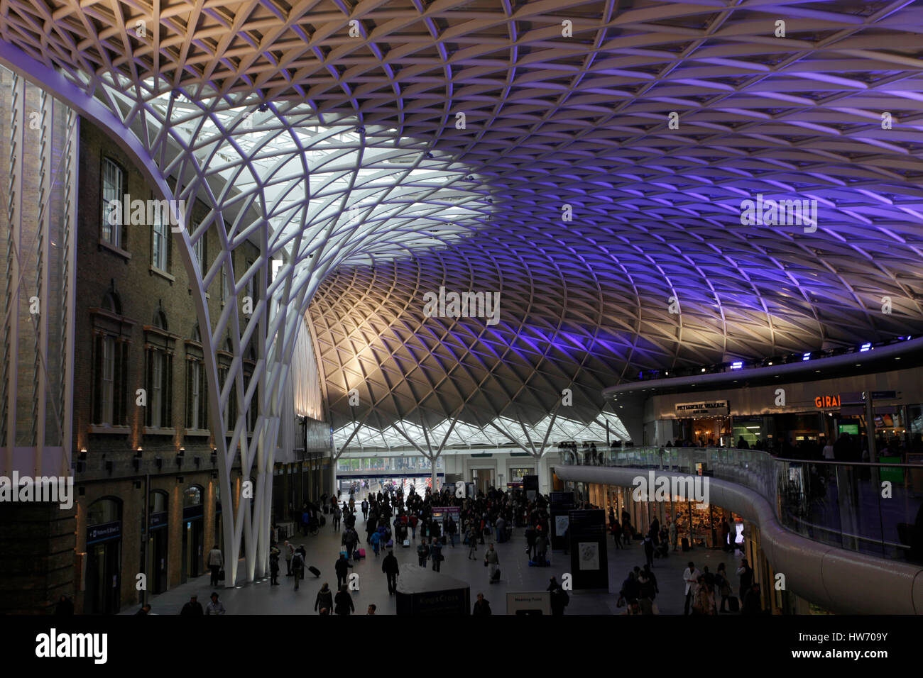 People on the concourse and departure boards; inside Kings Cross ...