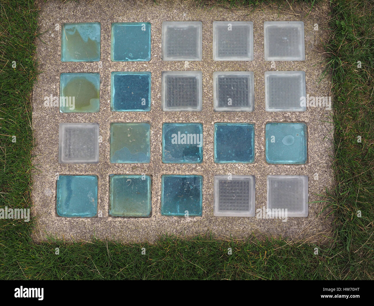 Coloured glass pavement lights in the garden Stock Photo - Alamy