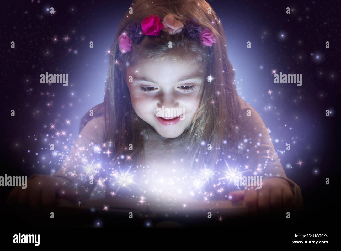 Beautiful little girl reading magic book; fantasy concept Stock Photo ...