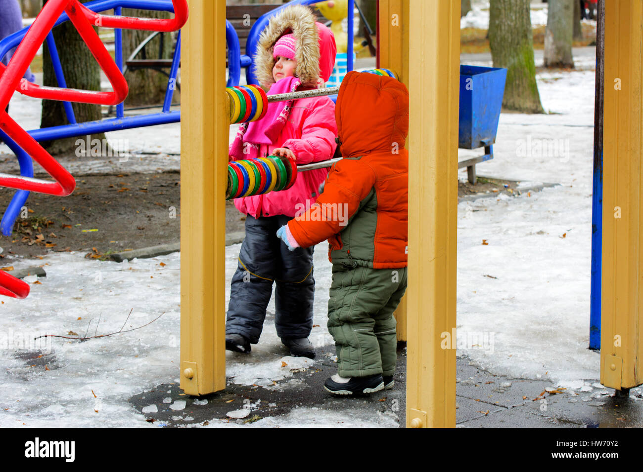 Little children play in the winter on the playground Stock Photo - Alamy