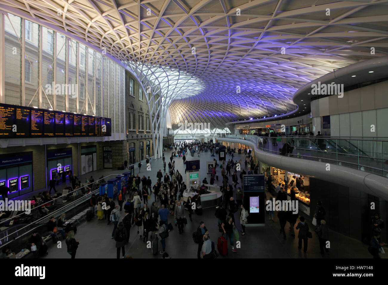 People on the concourse and departure boards; inside Kings Cross ...