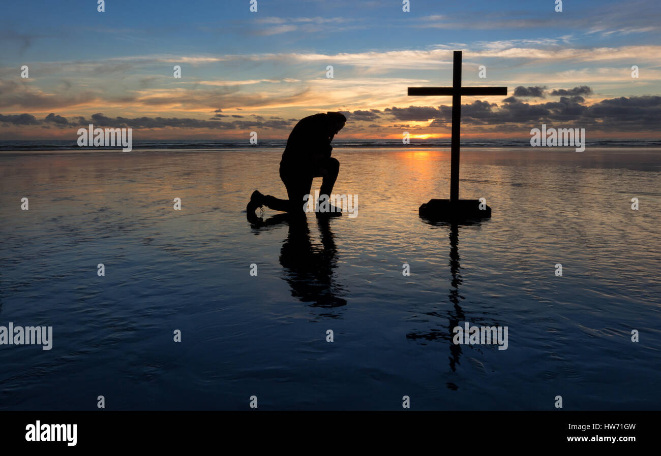 Kneeling In Prayer At The Cross