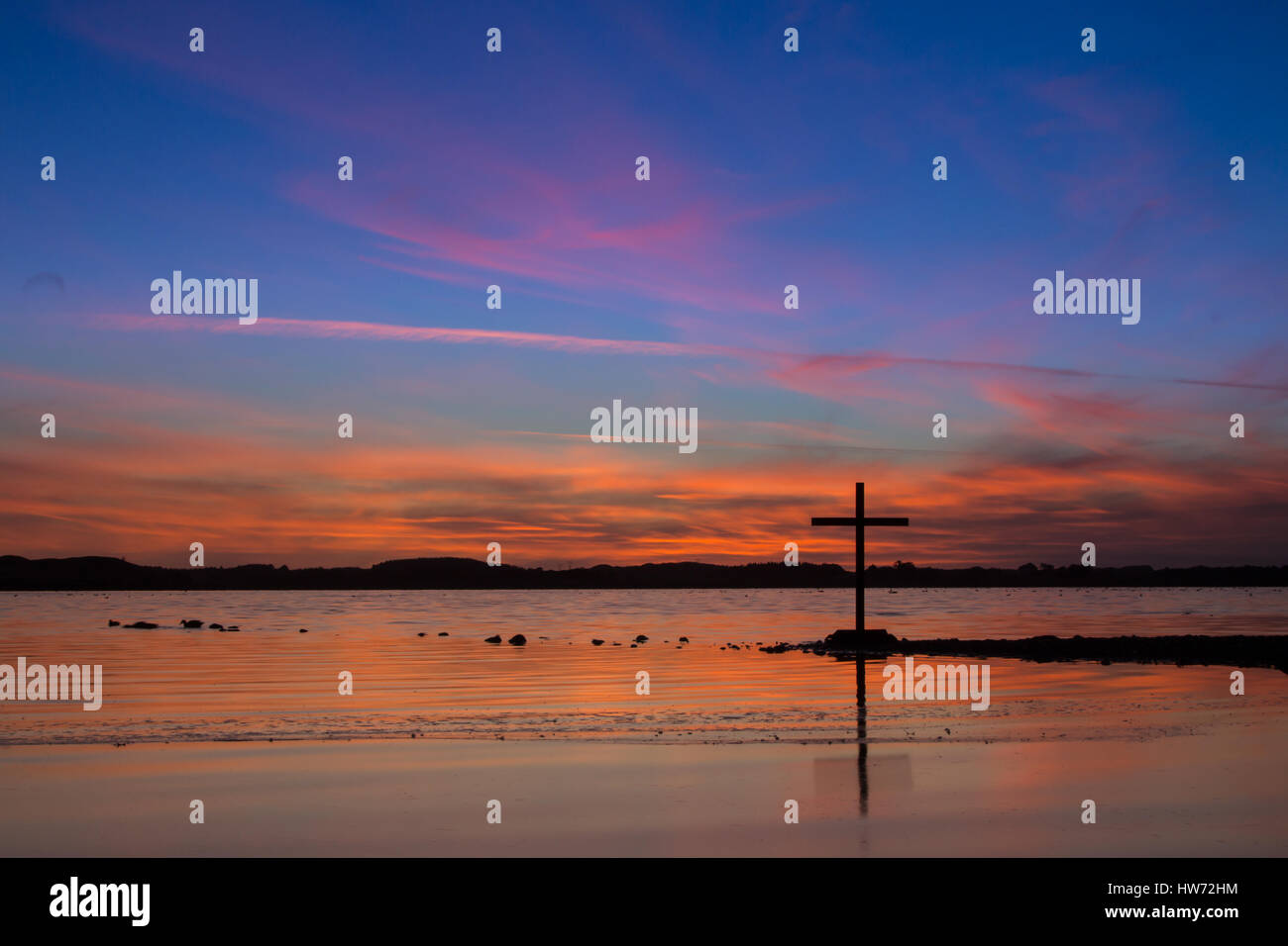 Lake at sunset of wonderful color, with a cross in it Stock Photo - Alamy