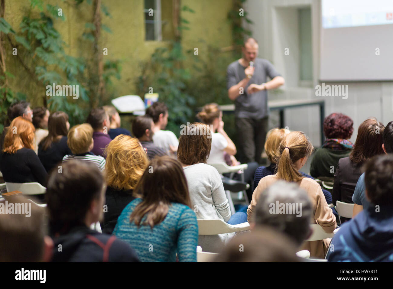 Man giving presentation in lecture hall at university Stock Photo - Alamy