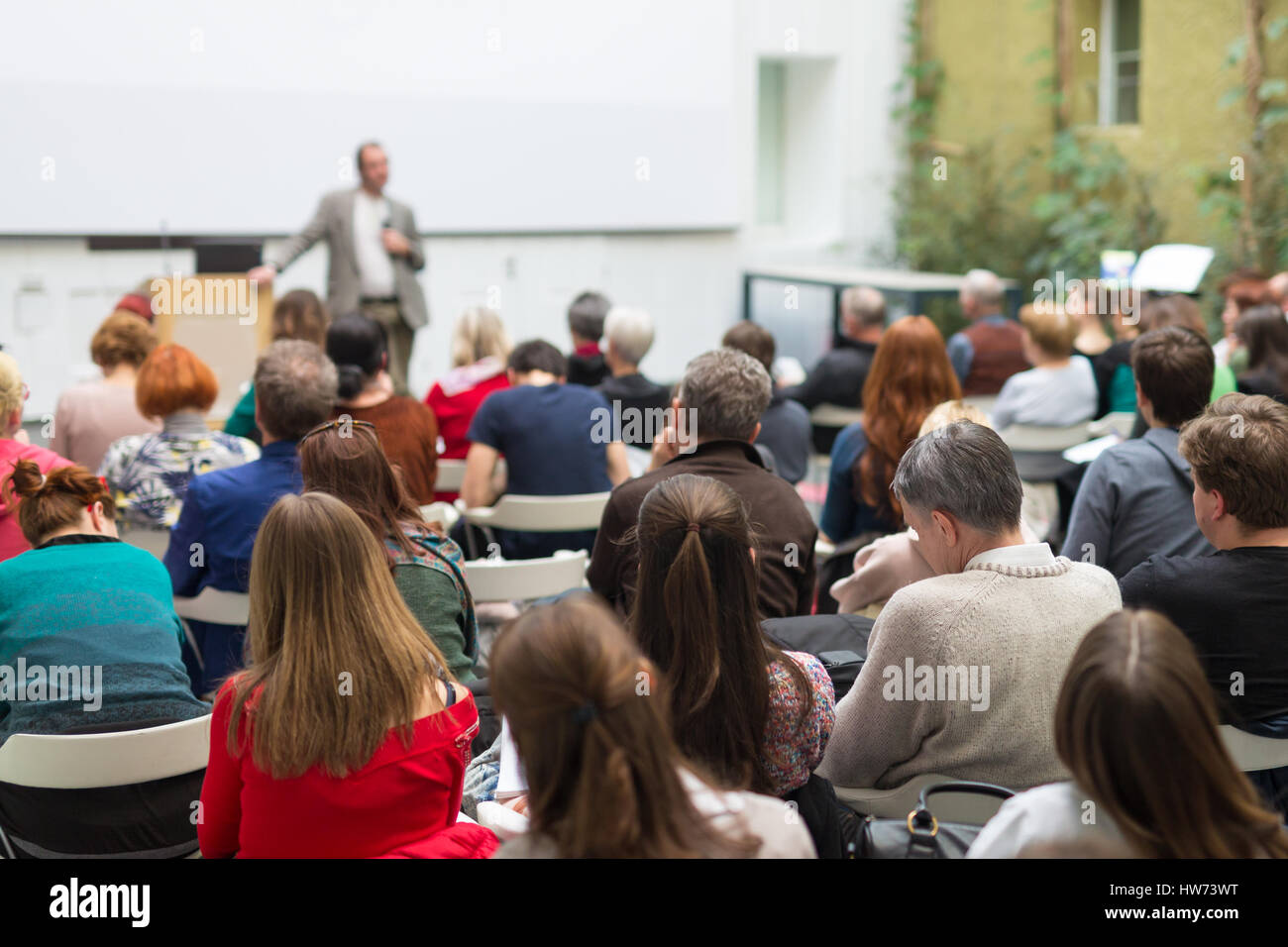 Man giving presentation in lecture hall at university Stock Photo - Alamy