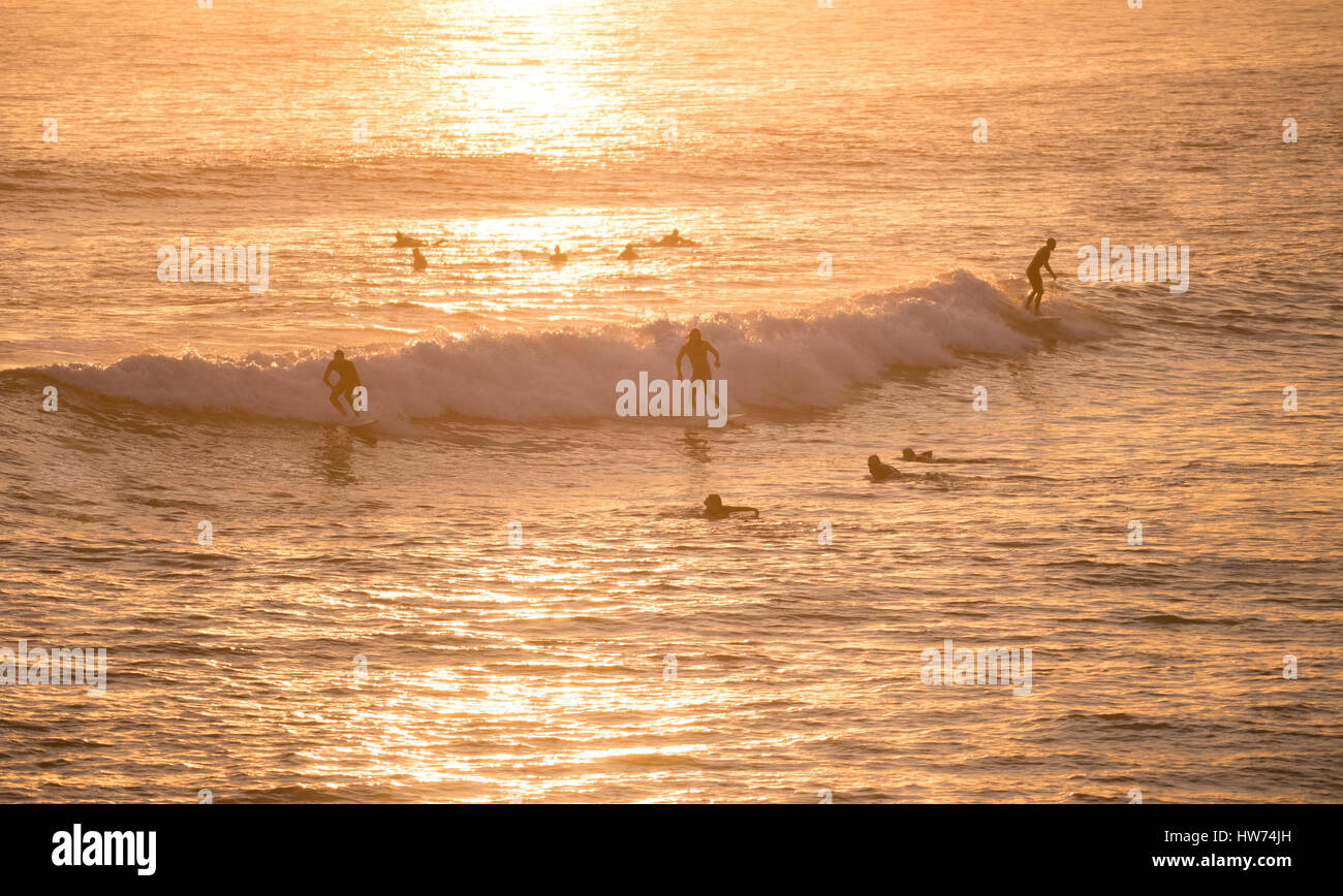 Surfers catching a wave in Huntington Beach, California. Surf City USA ...