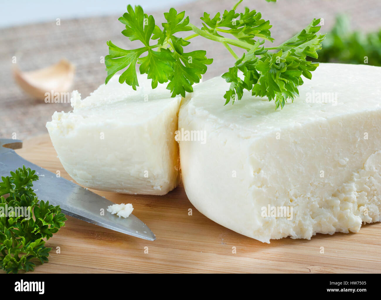 Cotija cheese with cilantro on cutting board Stock Photo - Alamy