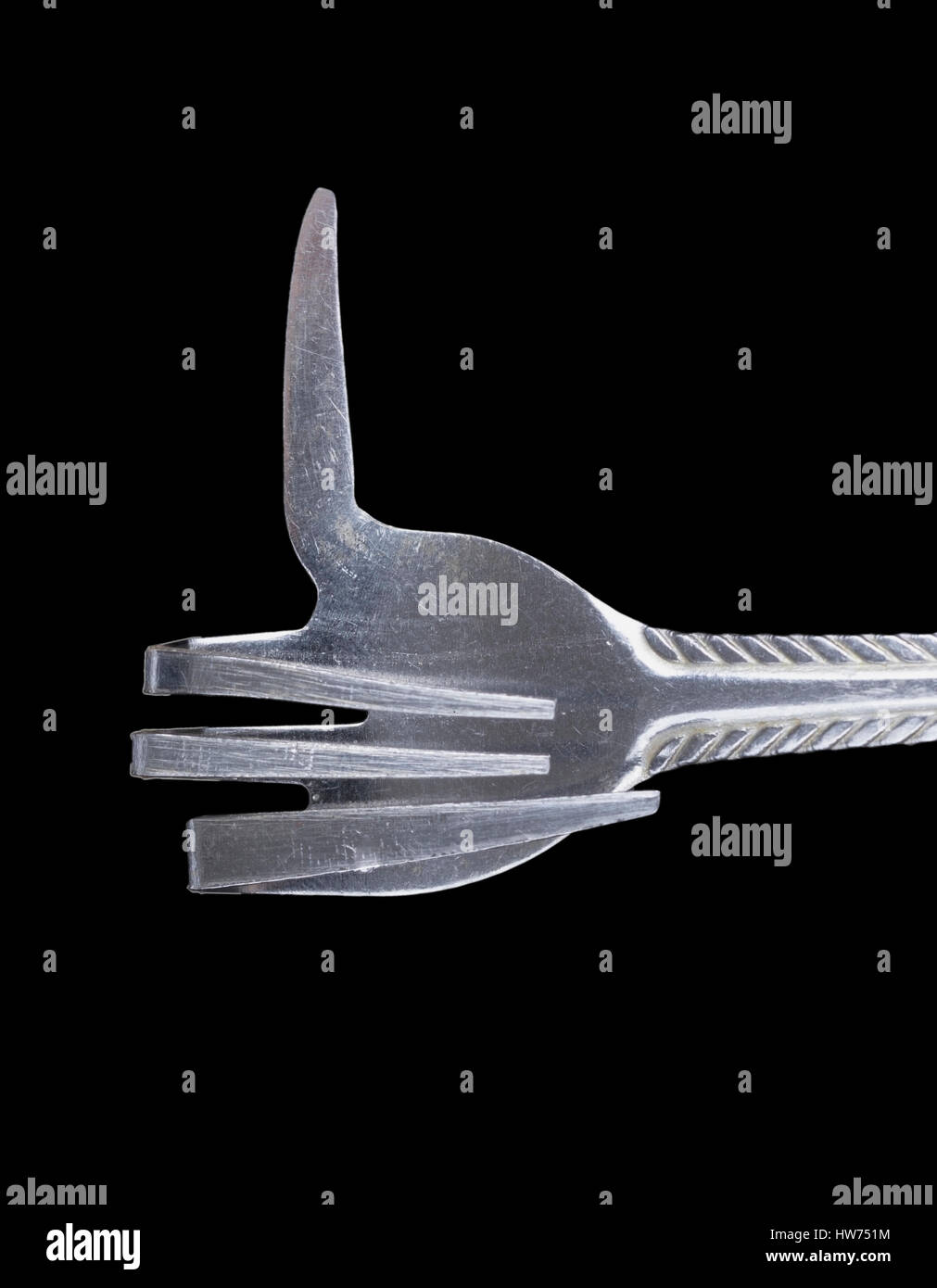 Bent metal fork isolated on black background. Different shapes and ...