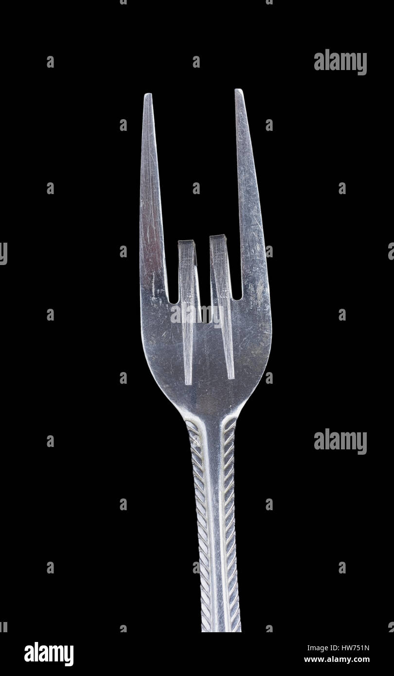 Bent metal fork isolated on black background.Heavy metal or rock sign ...