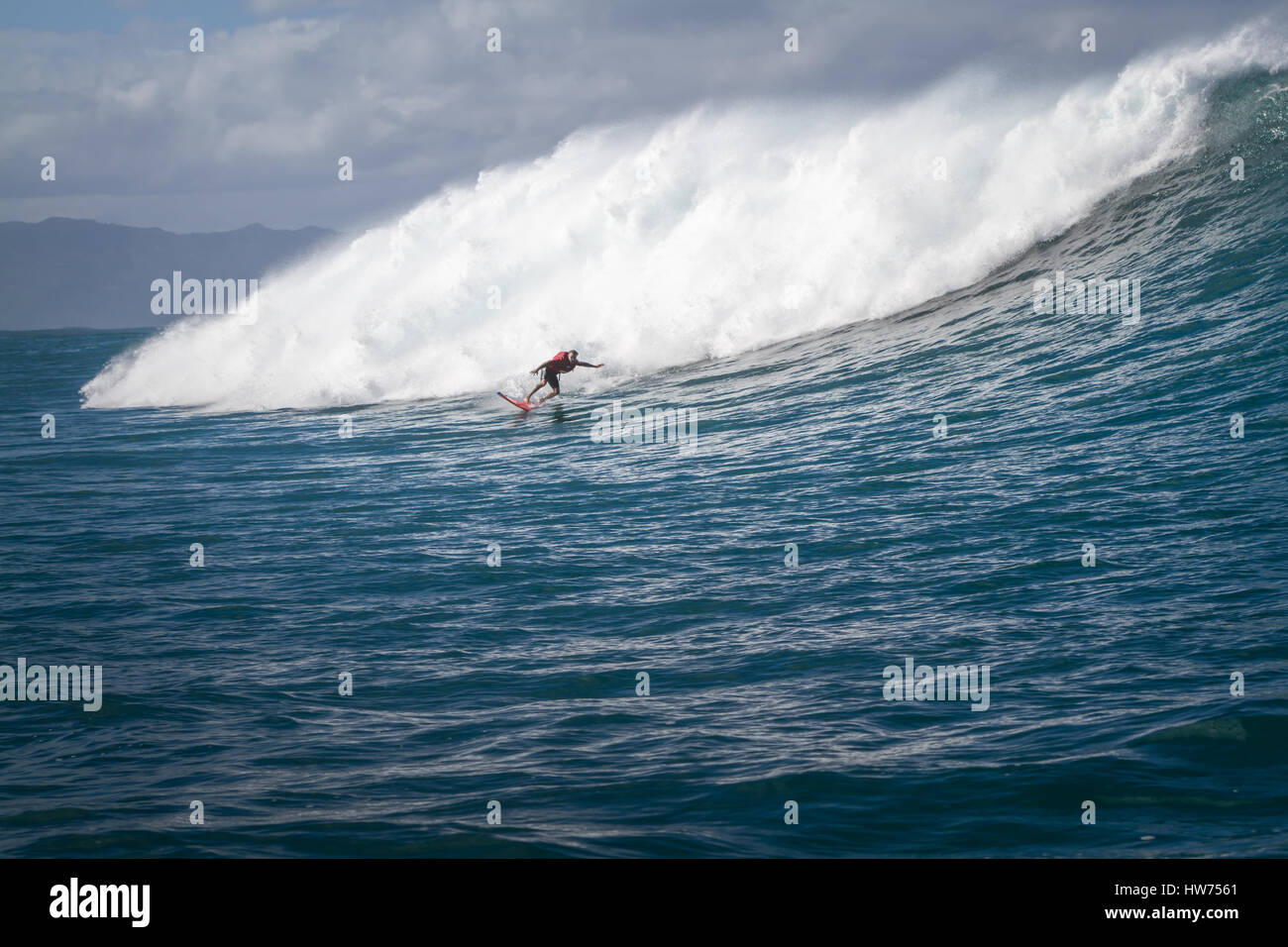 A Surfer rides a big Ocean wave on the north shore of Oahu Hawaii near ...