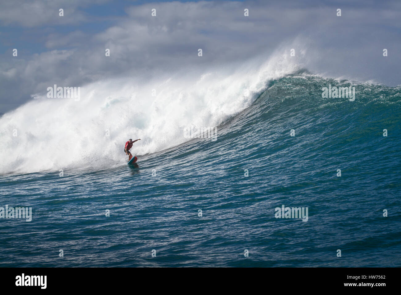 A Surfer rides a big Ocean wave on the north shore of Oahu Hawaii near ...