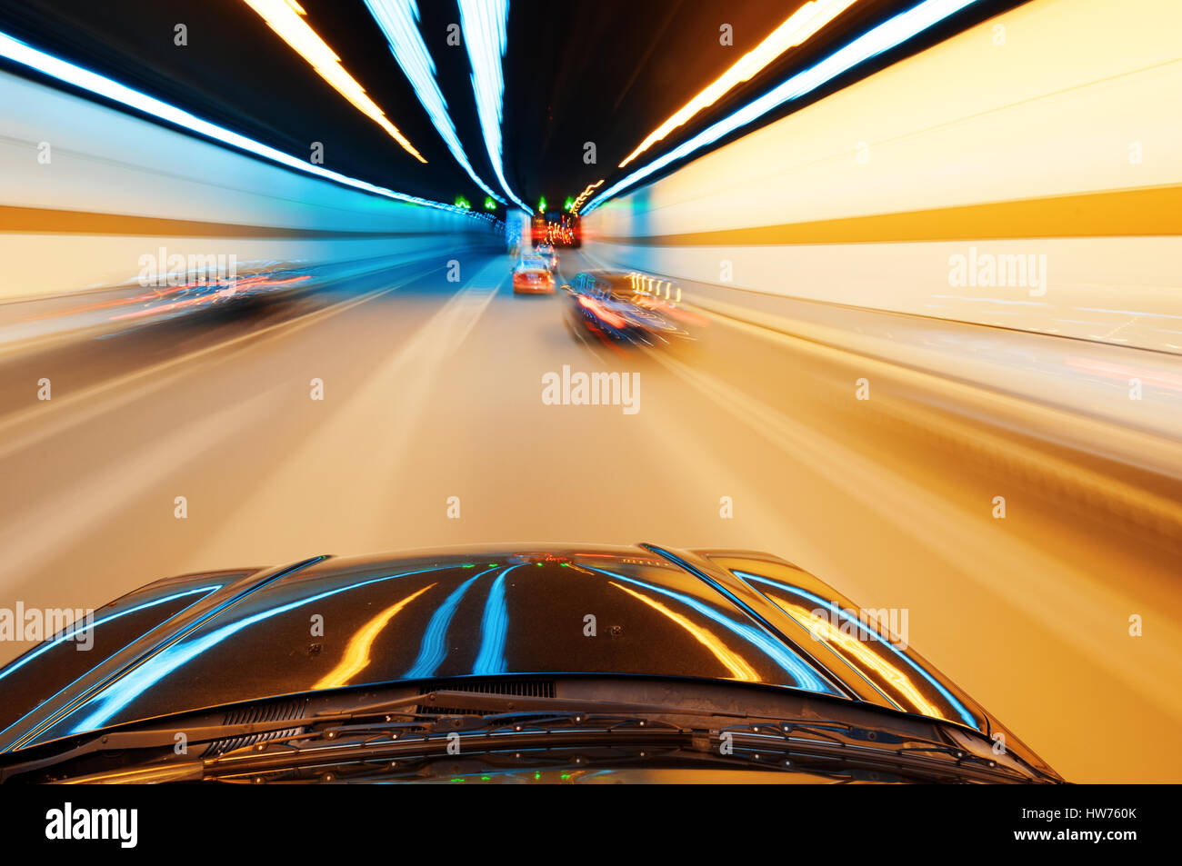 A car driving on a motorway at high speeds, overtaking other cars Stock ...