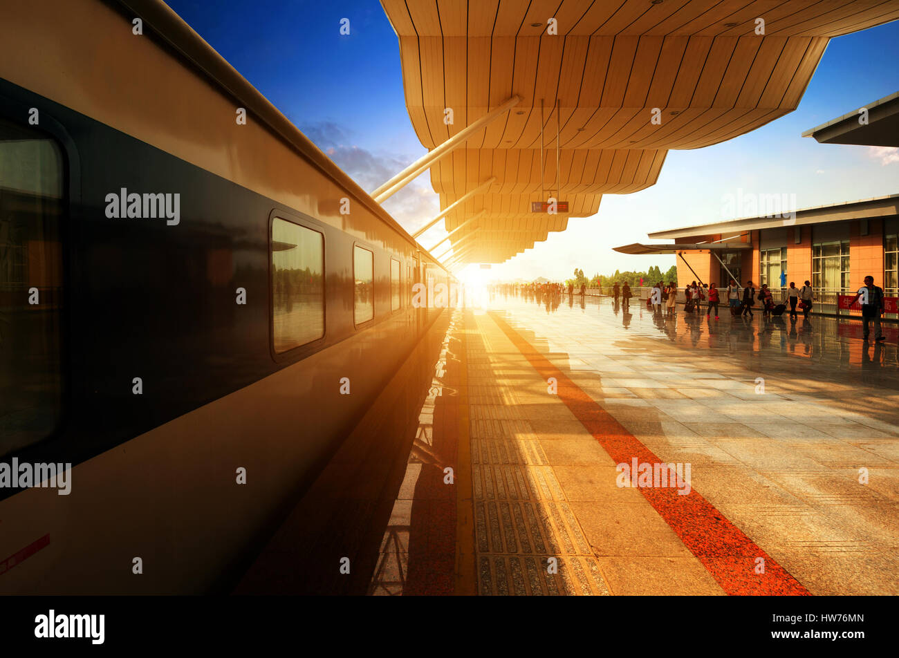 train stop at railway station with sunset Stock Photo - Alamy
