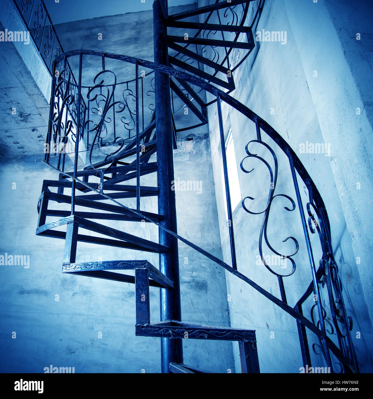 Sleek metal spiral staircase, modern architectural interior decoration ...