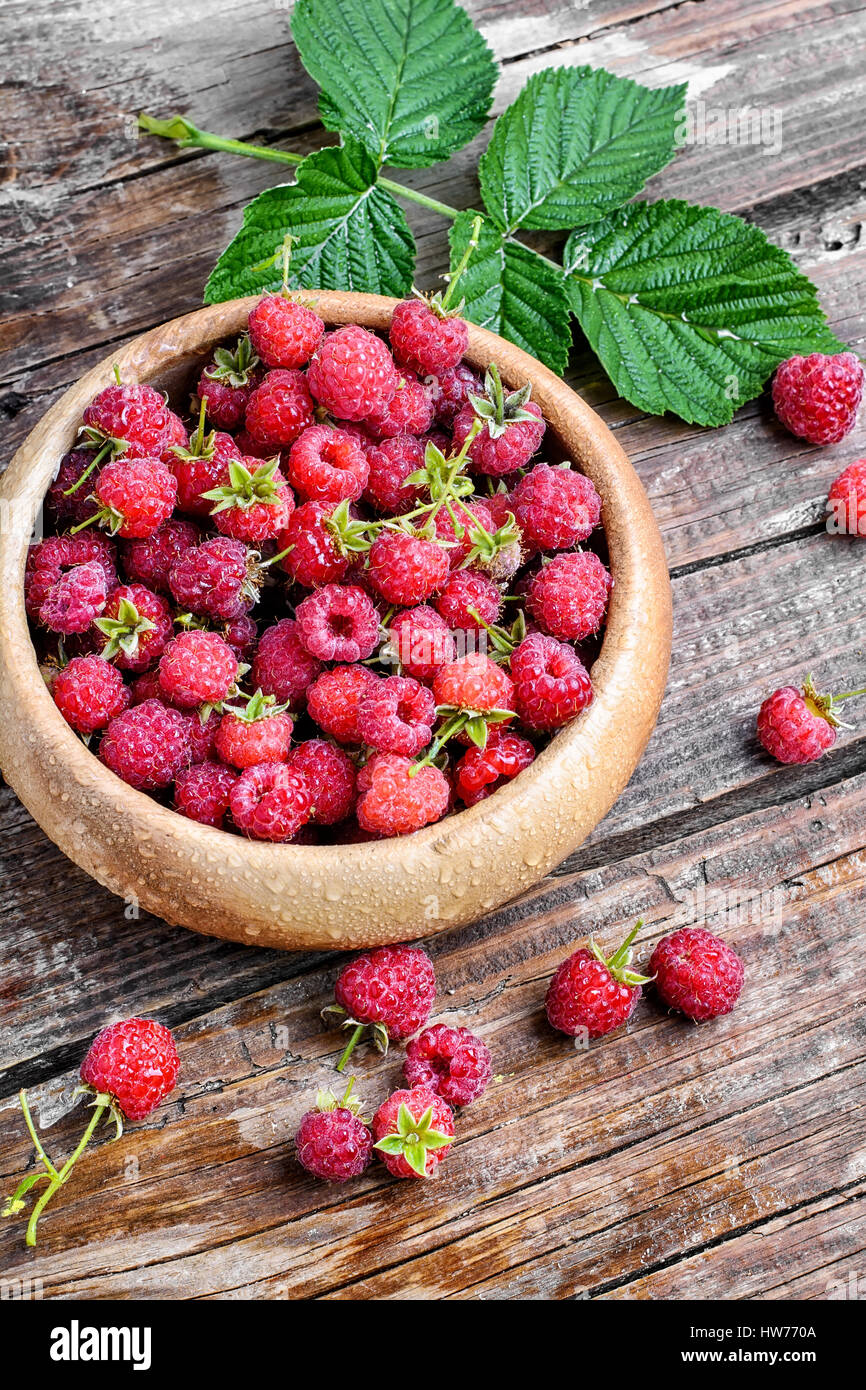 Summer crop of berries ripe raspberries in wooden bowl Stock Photo - Alamy