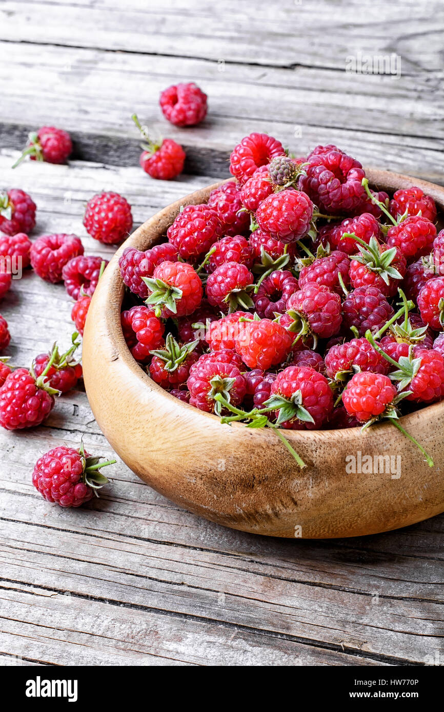 Summer crop of berries ripe raspberries in wooden bowl Stock Photo - Alamy