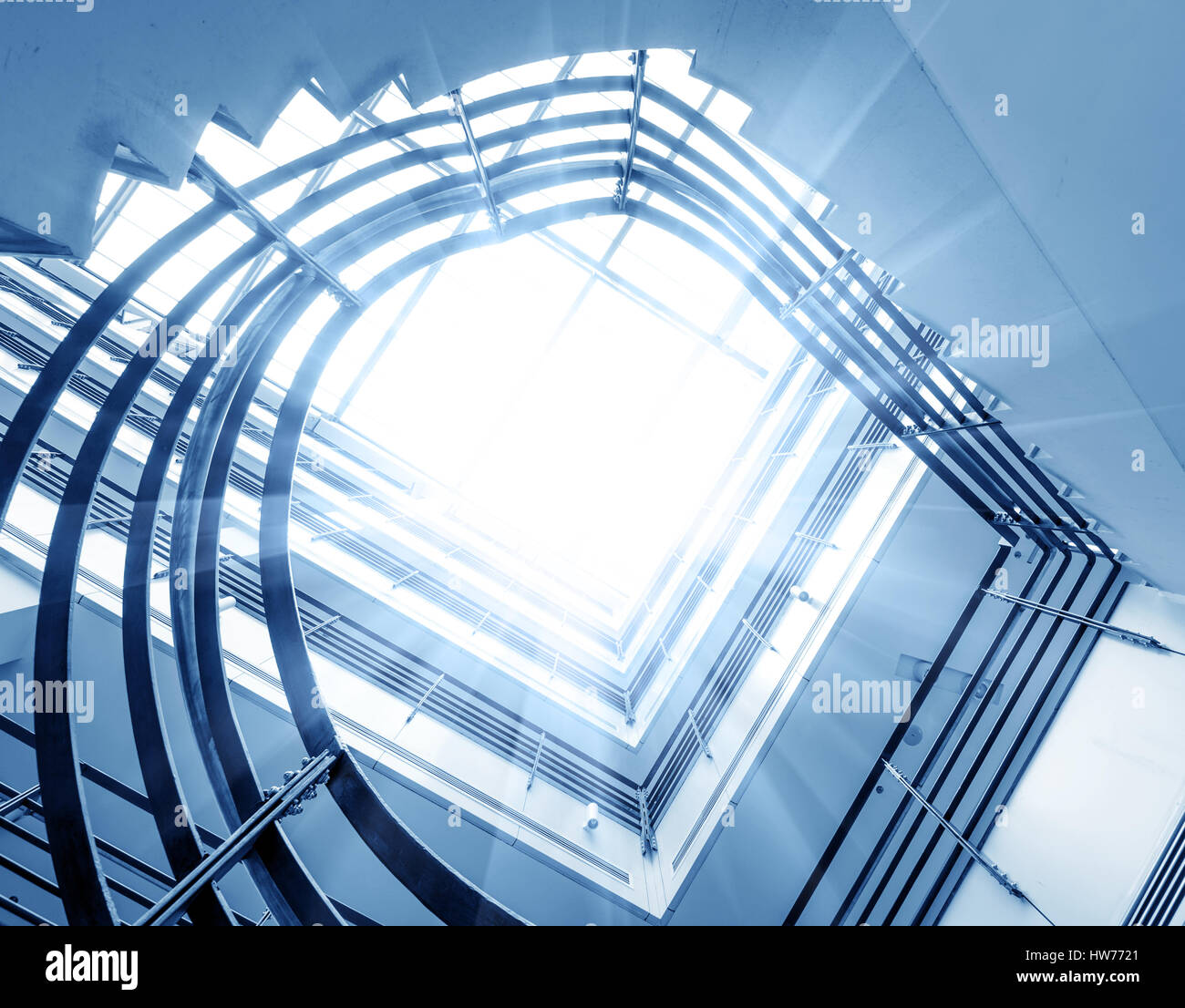 Sleek metal spiral staircase, modern architectural interior decoration ...