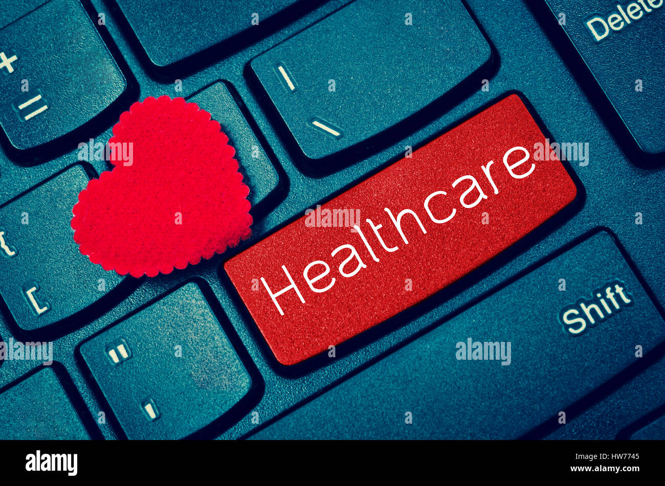 Computer keyboard and red heart with word Healthcare Stock Photo - Alamy