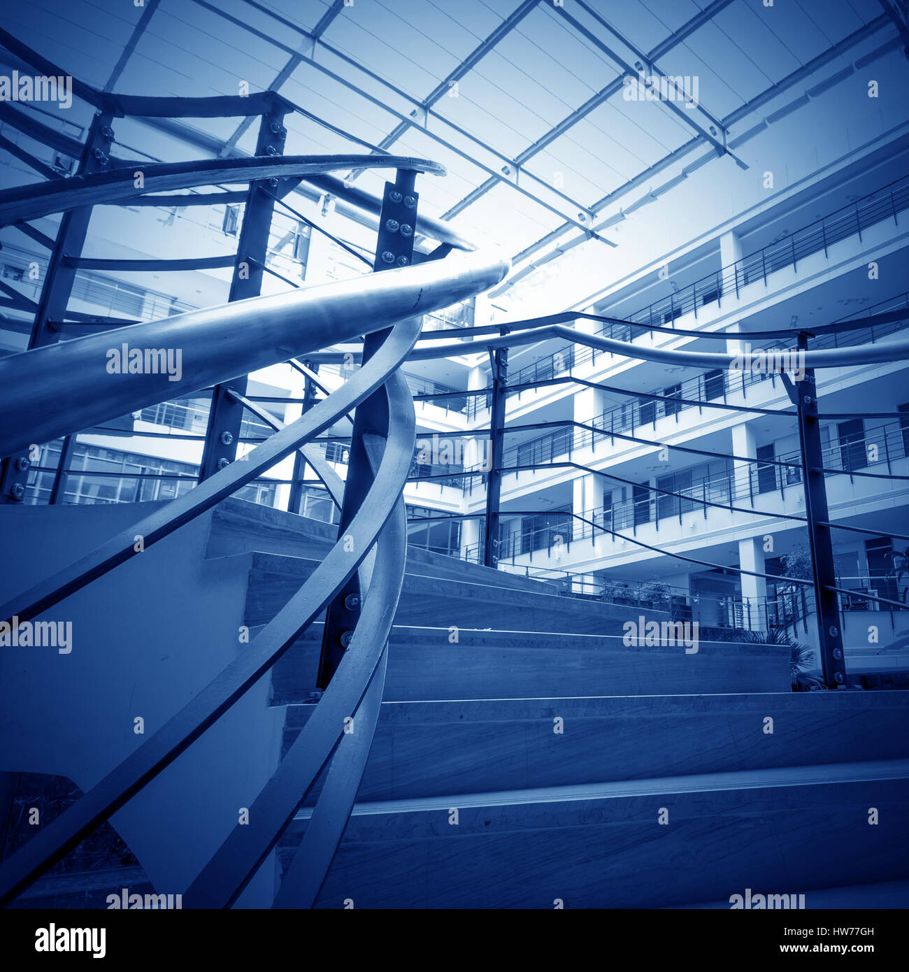 Sleek metal spiral staircase, modern architectural interior decoration ...