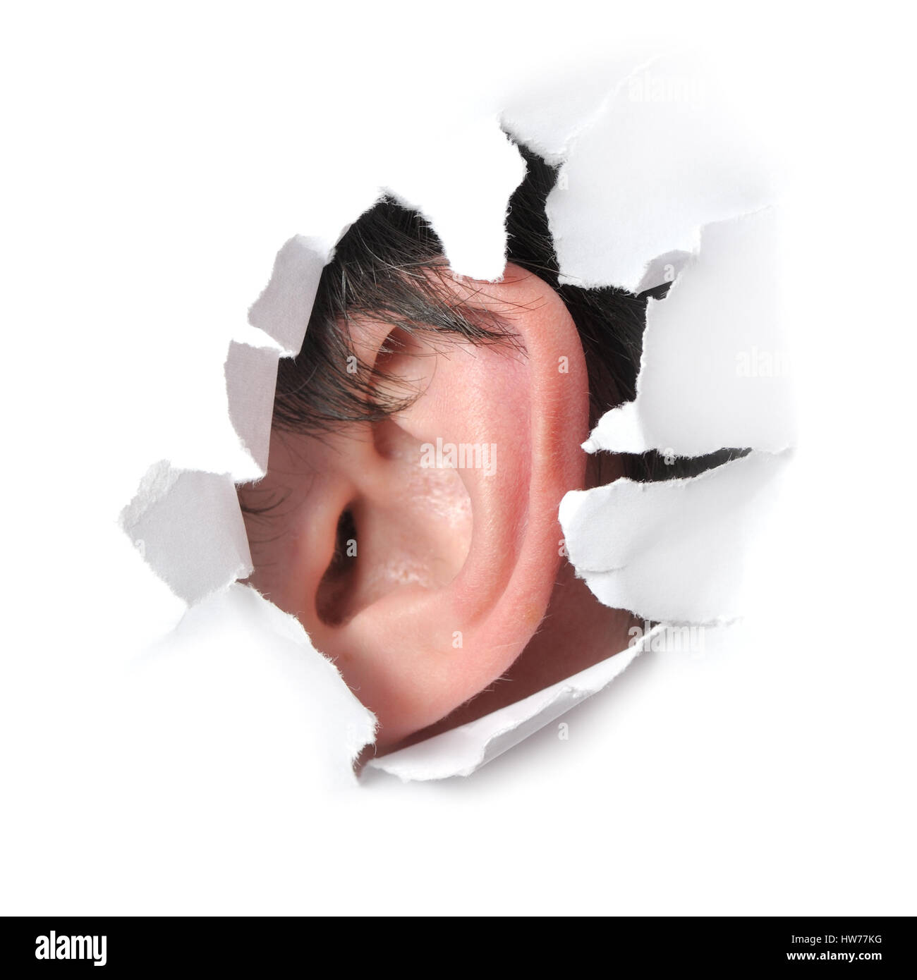 Ear in the hole of a paper Stock Photo - Alamy