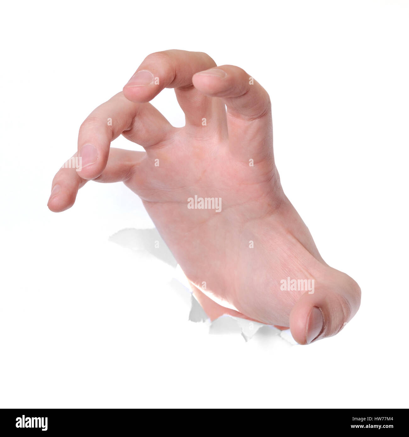 Hand punching through paper isolated on white background Stock Photo ...