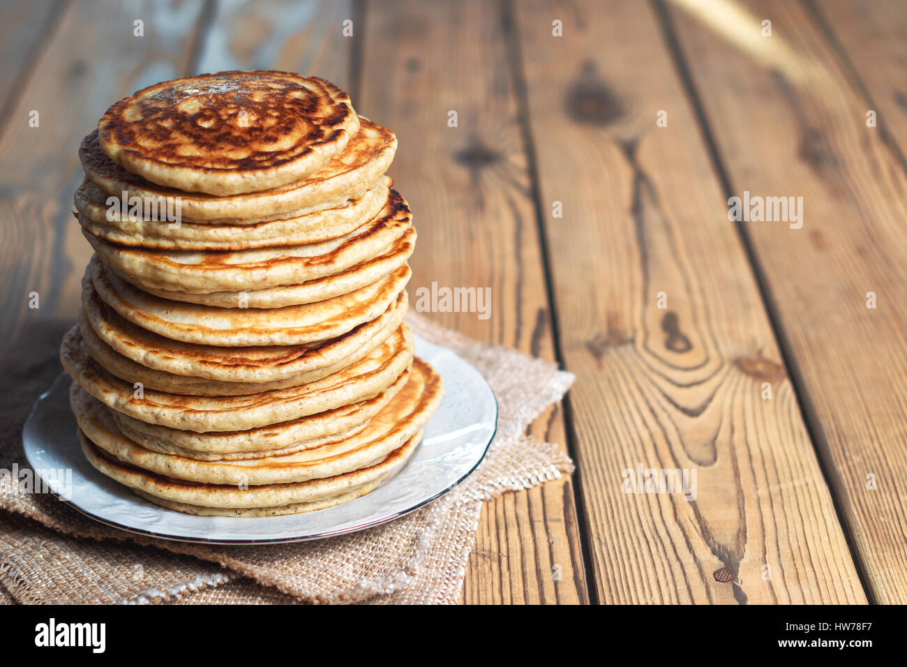 High stack of Oatmeal pancakes. The rustic style. With copy space ...