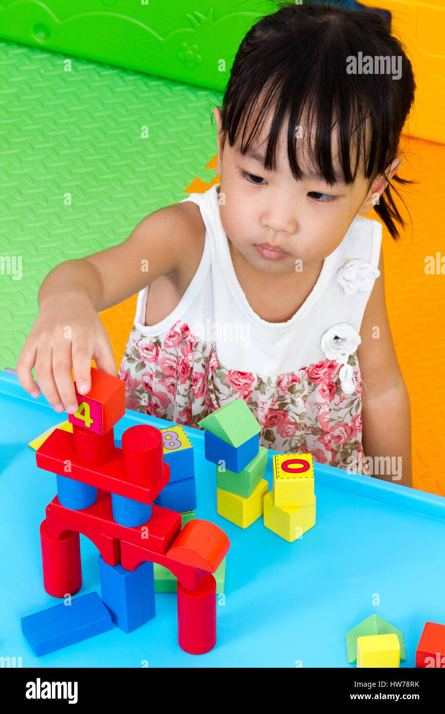 Asian Little Chinese Girl Playing Wooden Blocks at Home or Kindergarten ...