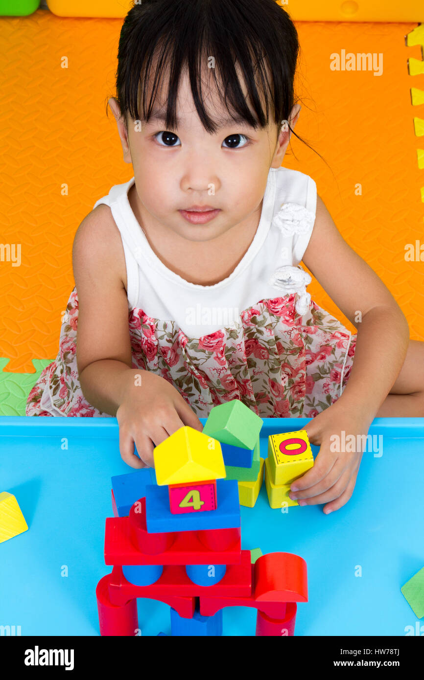 Asian Little Chinese Girl Playing Wooden Blocks at Home or Kindergarten ...