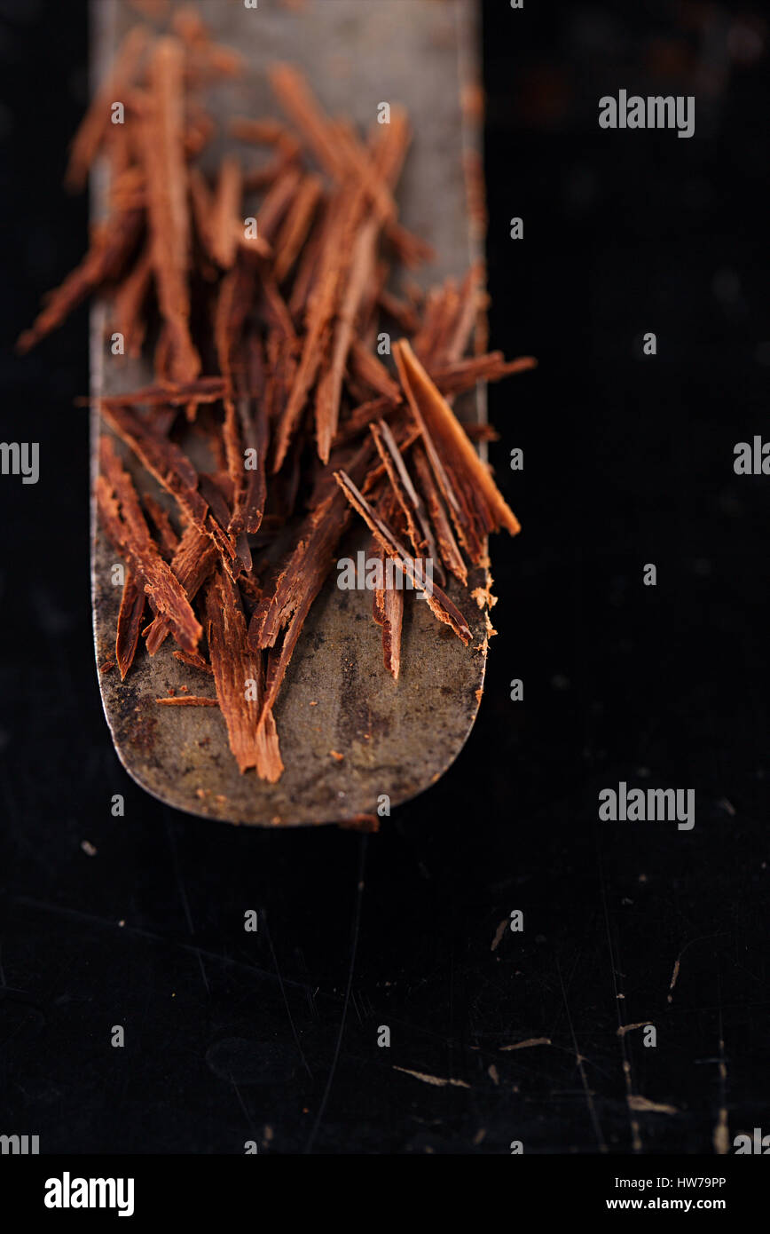 shredded chocolate on vintage spatula and dark metal background, macro ...