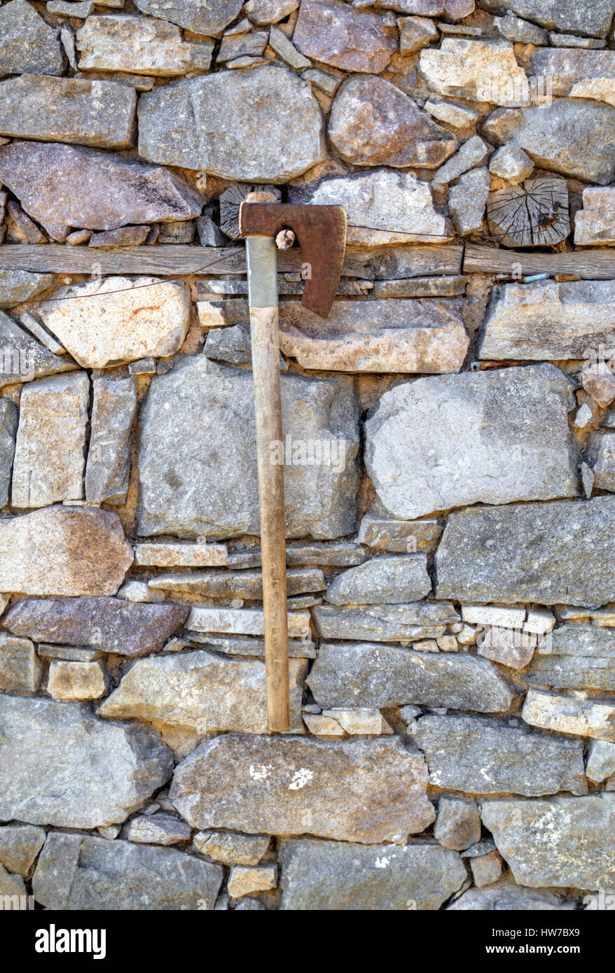 Stylish stone wall background and axe Stock Photo - Alamy