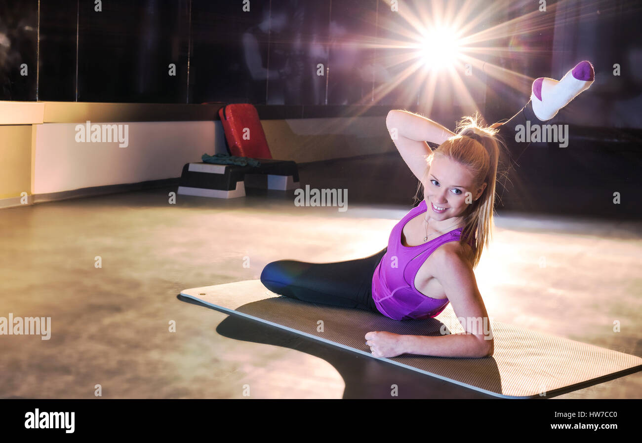 Young athletic woman doing pilates stretching exercises Stock Photo - Alamy