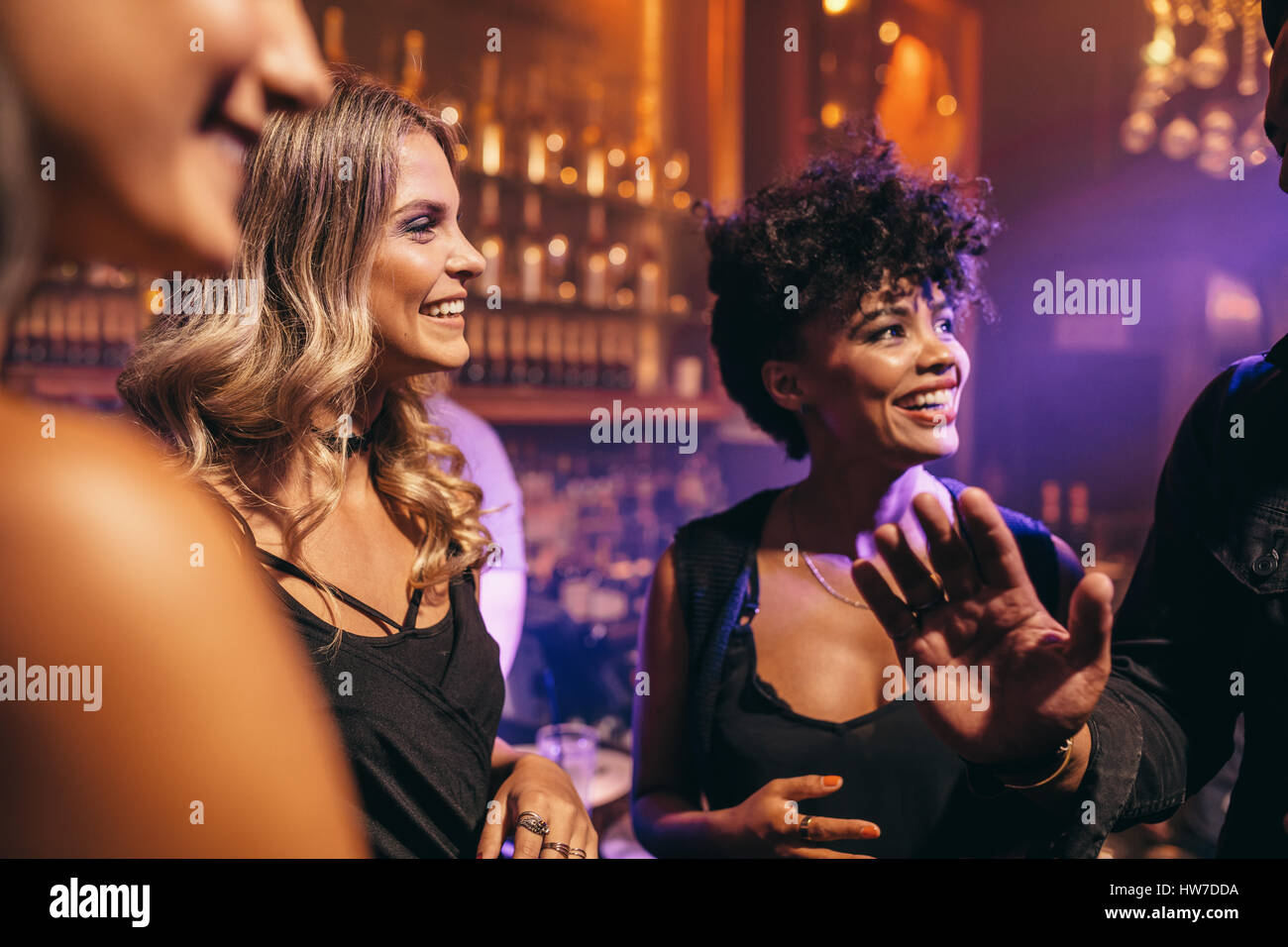 Group of young friends enjoying a night at pub. Young people having fun ...