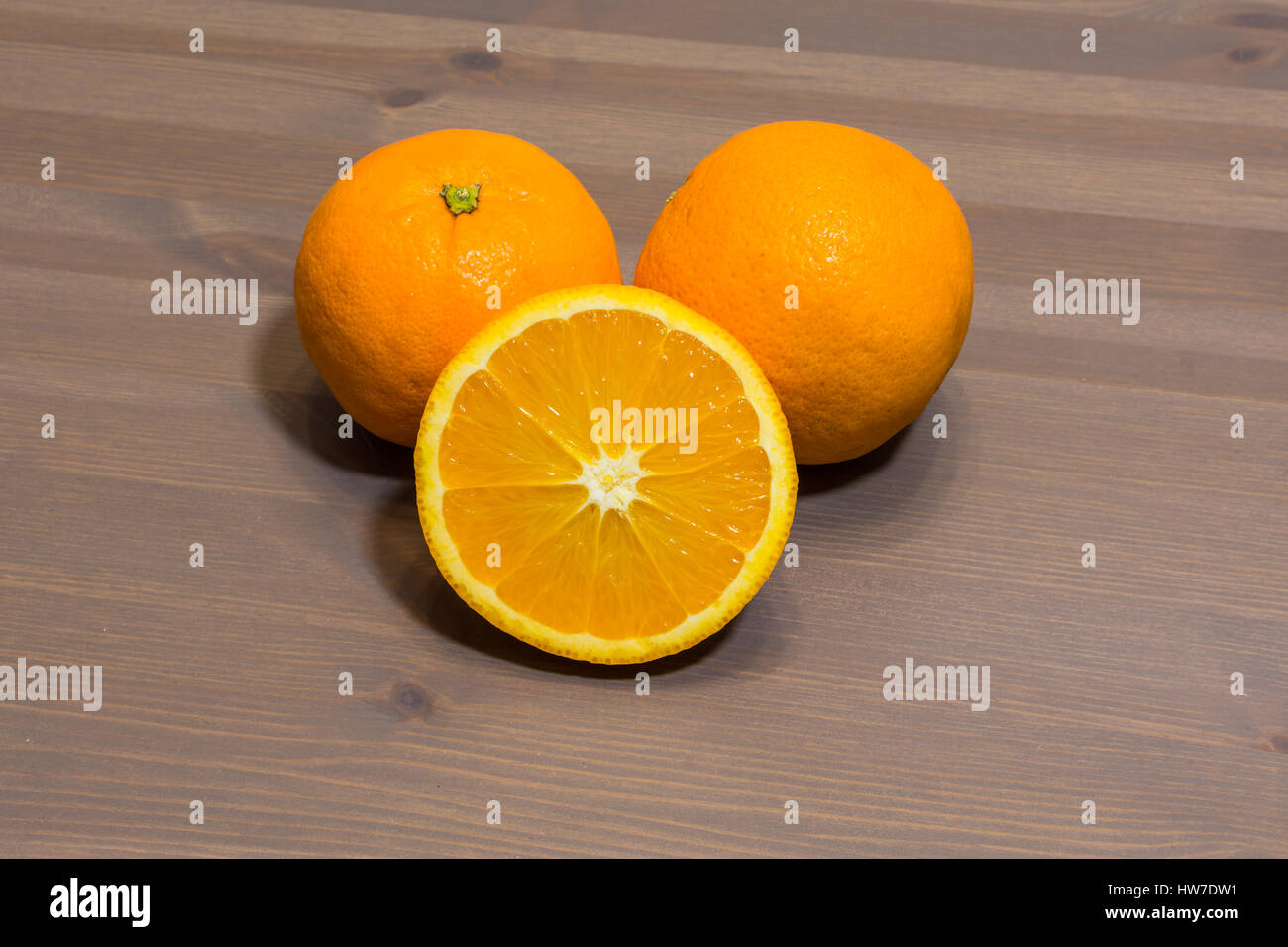 Orange fruit sliced isolated on wood background Stock Photo - Alamy