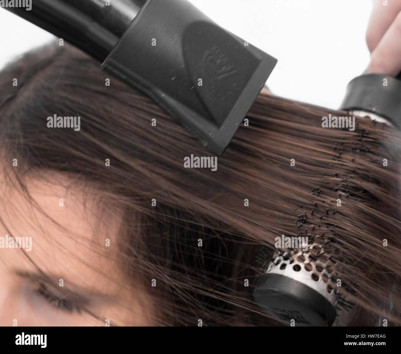 Detail of drying hair with hair dryer and brush at the hairdresser ...
