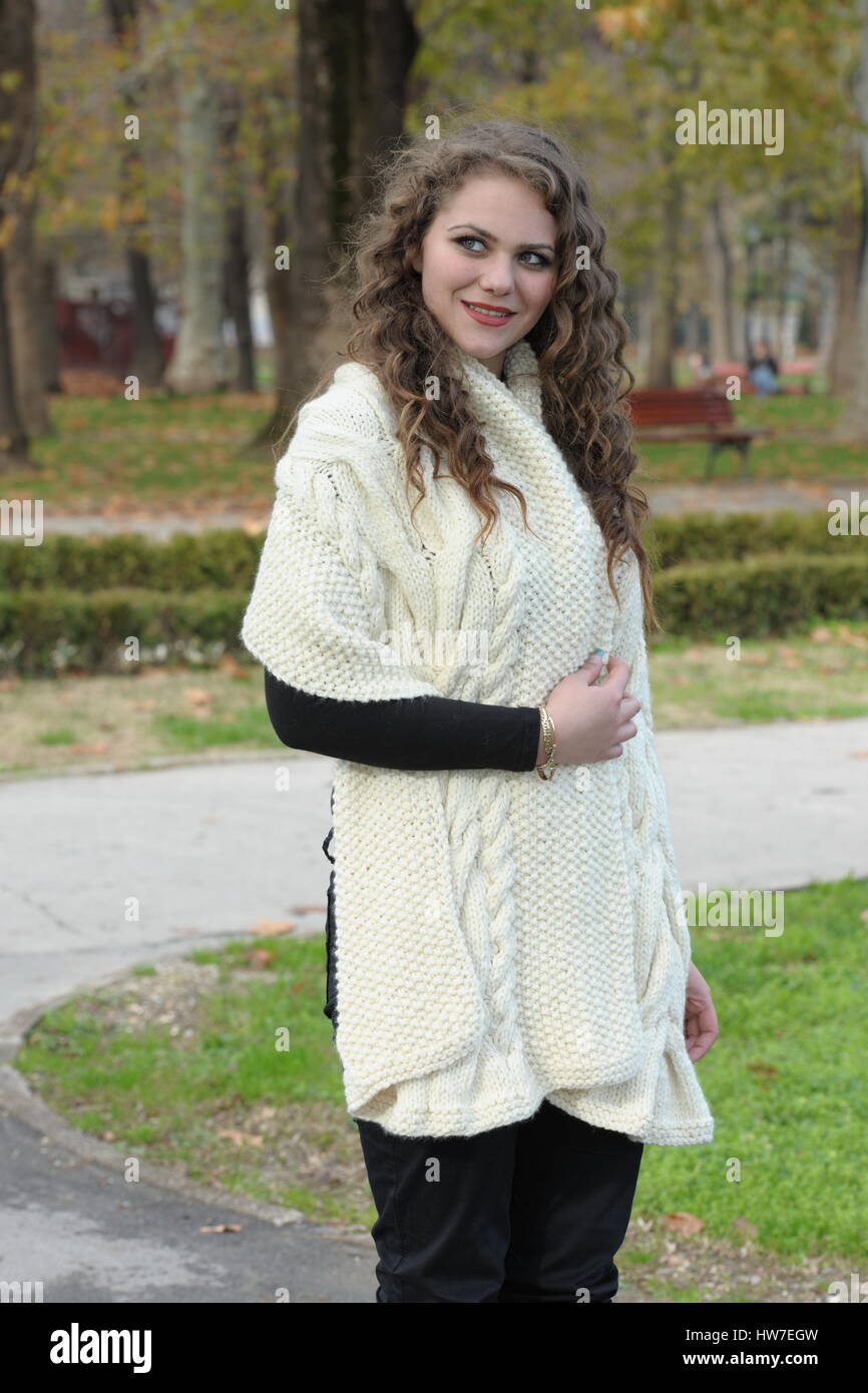 Blonde girl in white handmade knitted scarf standing posing Stock Photo ...
