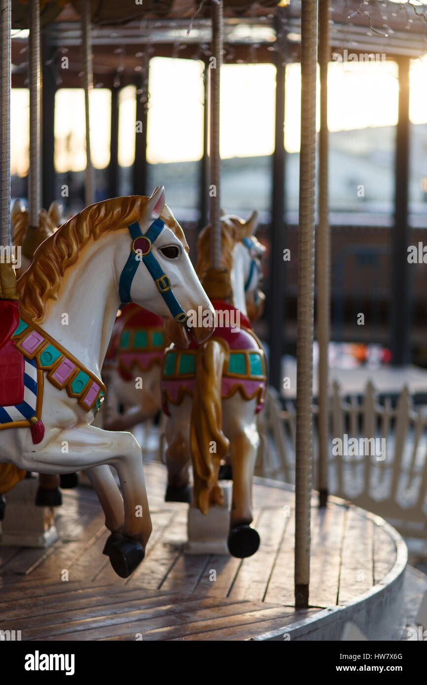 Children's carousel with horses outdoor Stock Photo - Alamy