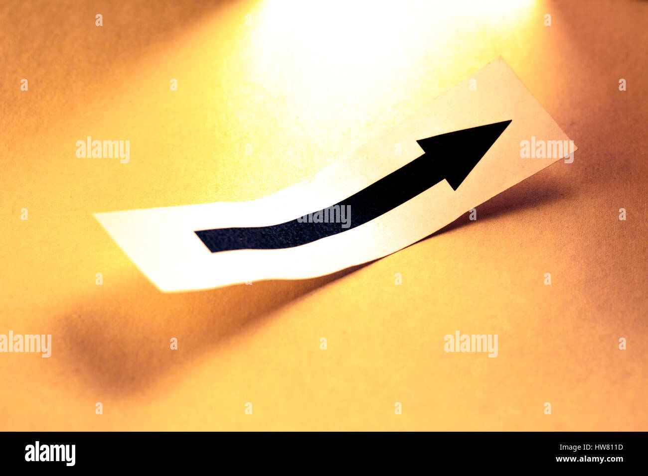 Black arrow on paper in light background Stock Photo - Alamy