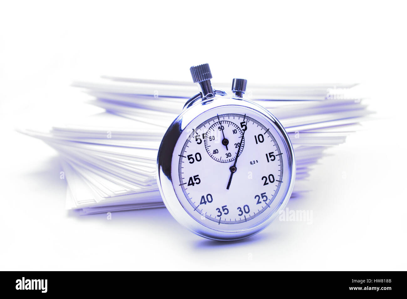 Pile of paper cards and stopwatch Stock Photo - Alamy
