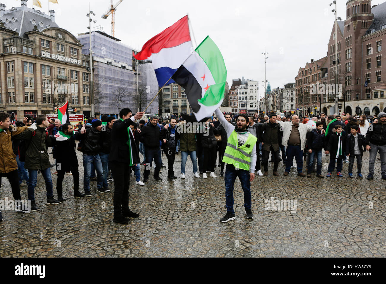 Two Syrians wave a Dutch and a Syria Independence flag. Syrians living ...