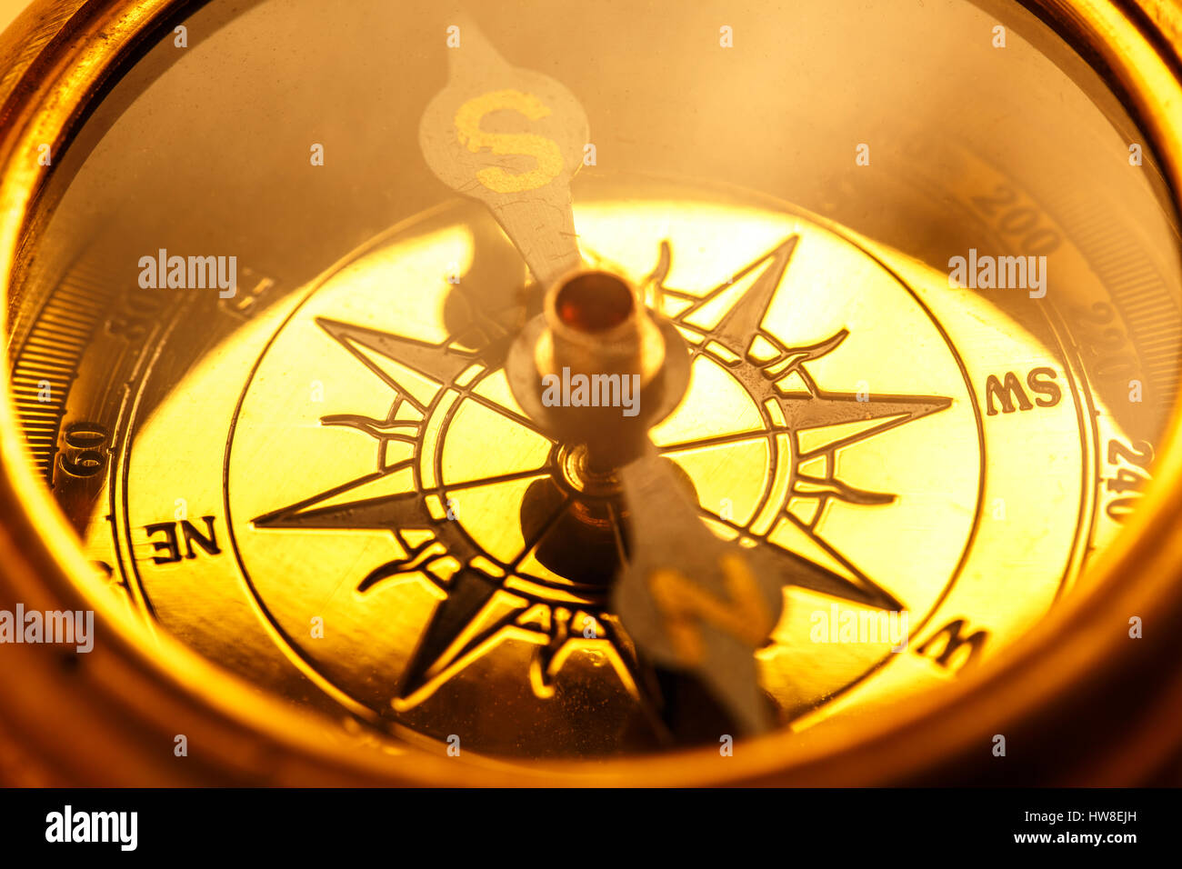 Vintage metal compass in toning light closeup Stock Photo - Alamy