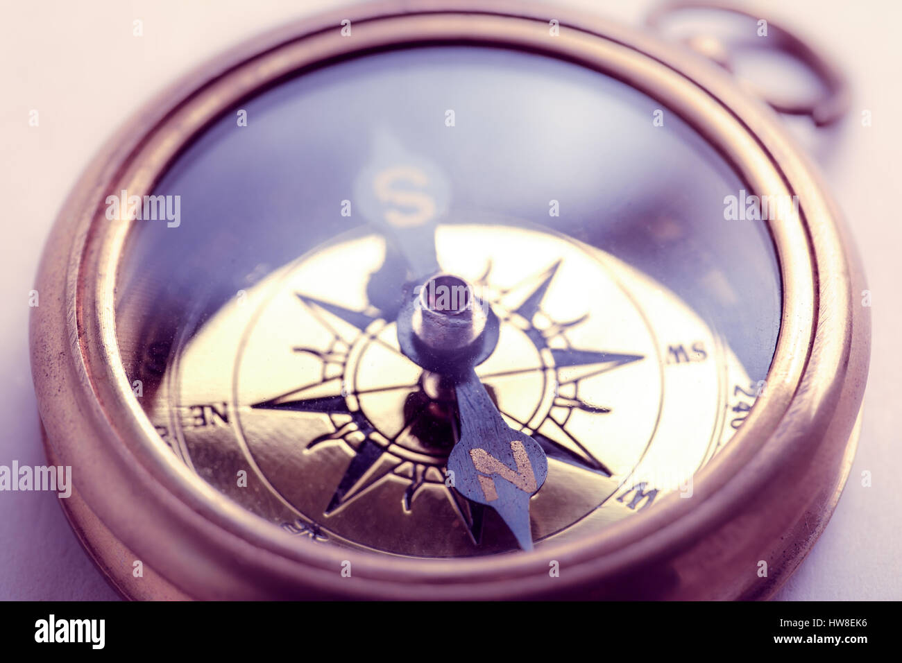 Vintage metal compass in toning light closeup Stock Photo - Alamy