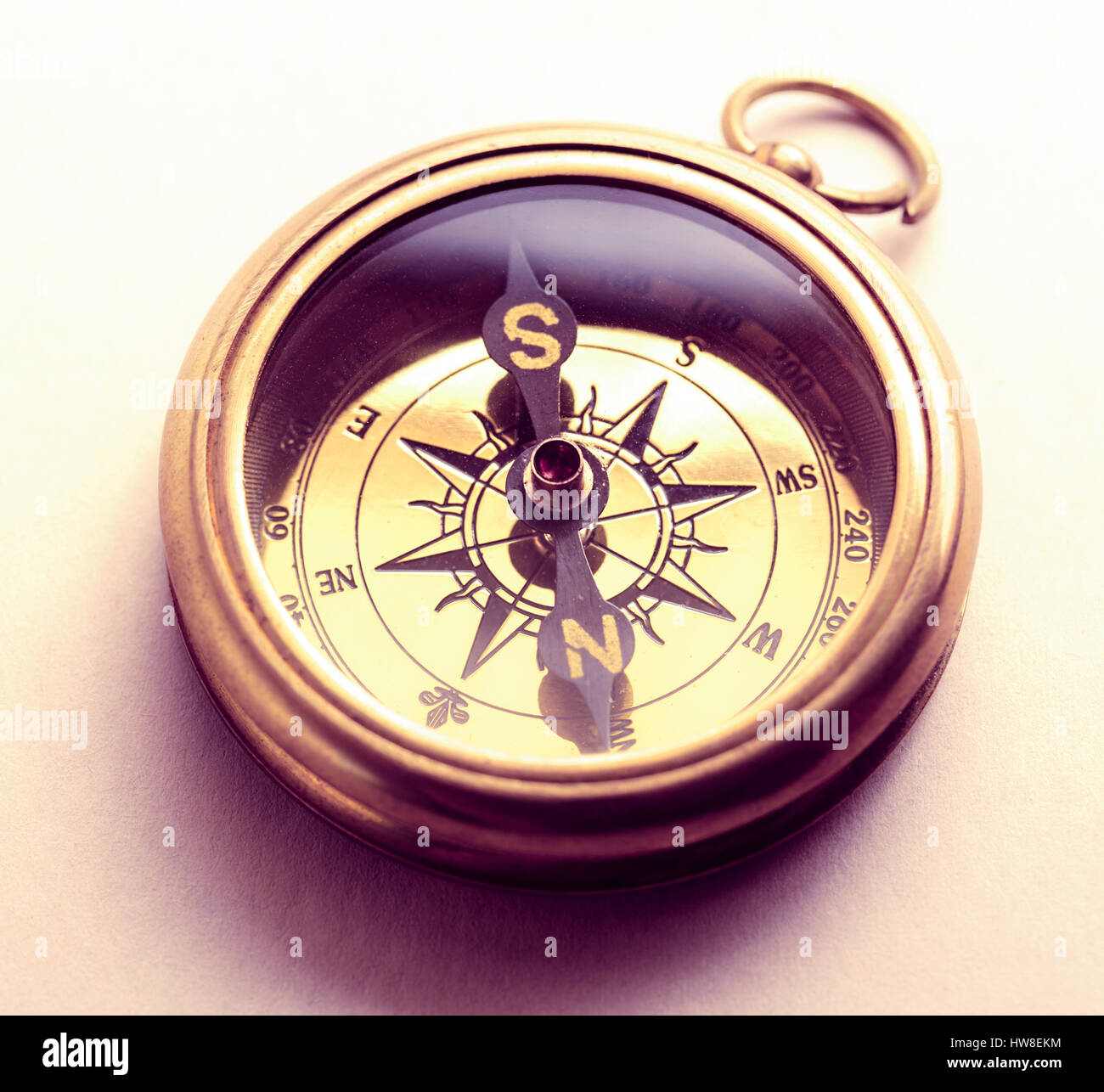 Vintage metal compass in toning light closeup Stock Photo - Alamy