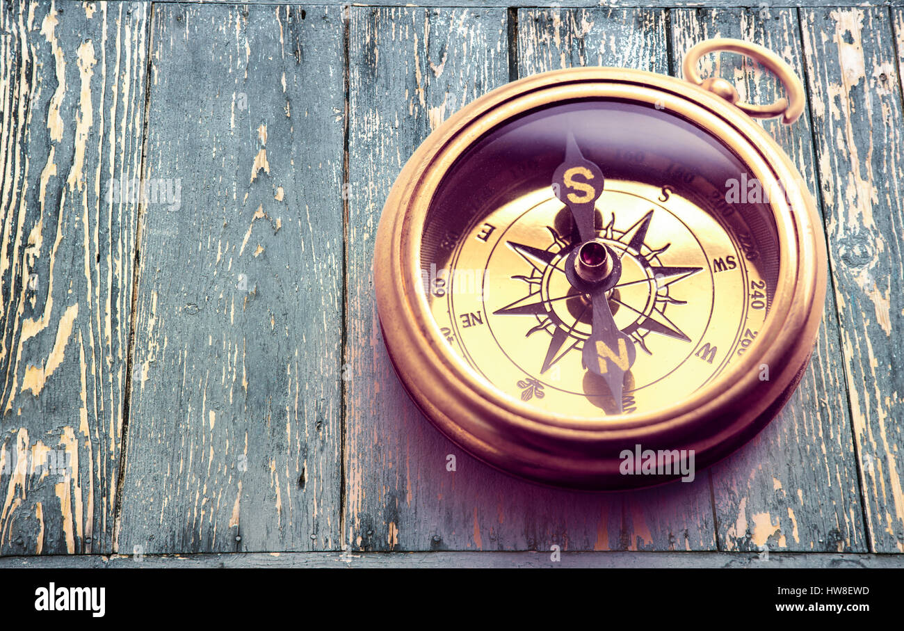 Vintage metal compass in toning light closeup Stock Photo - Alamy