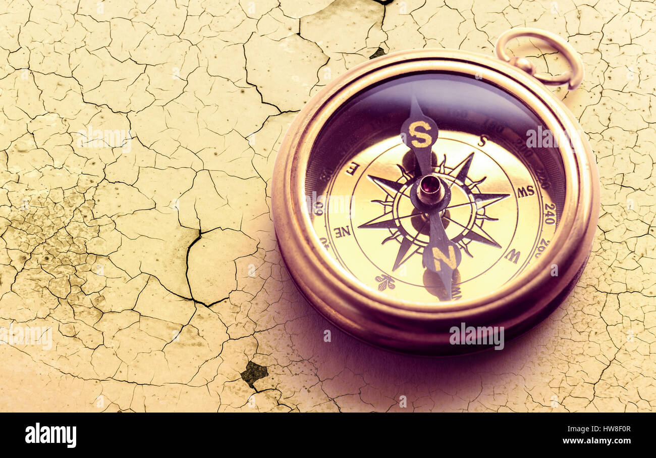 Vintage metal compass in toning light closeup Stock Photo - Alamy