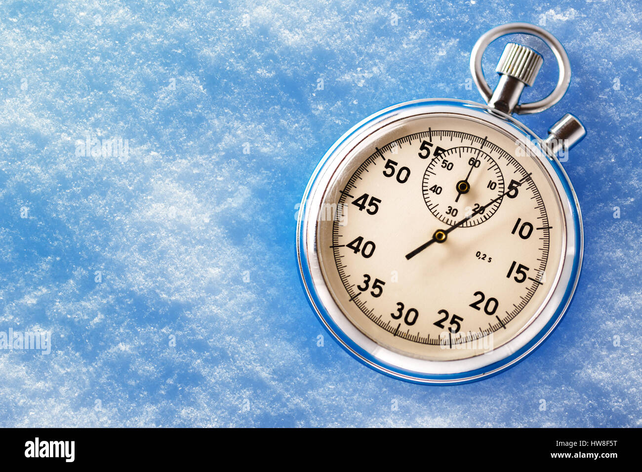 Stopwatch on blue background in closeup Stock Photo - Alamy