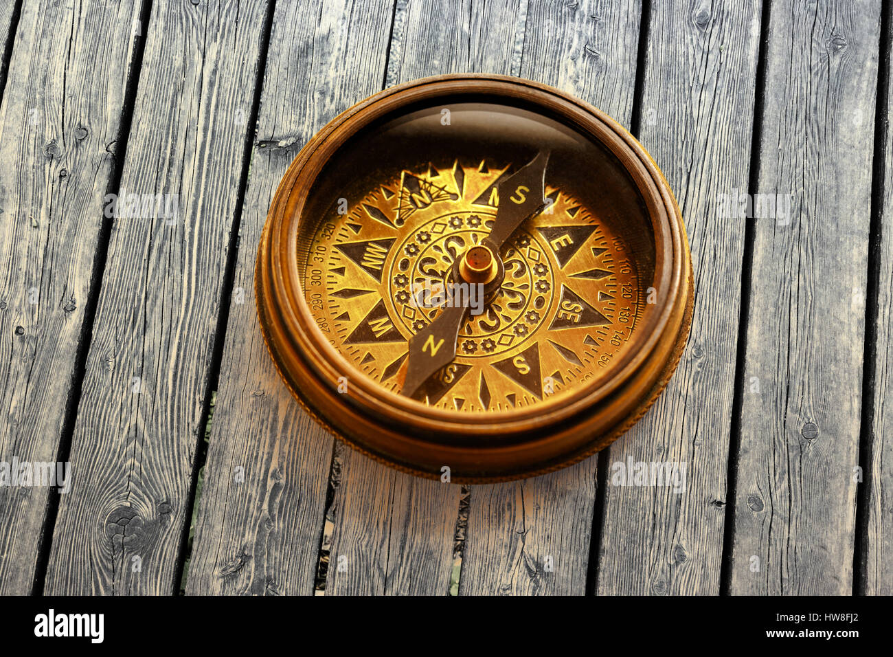 Vintage metal compass in toning light closeup Stock Photo - Alamy