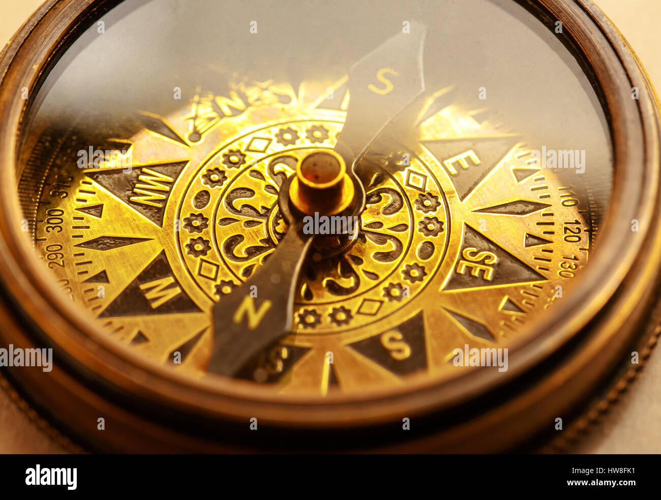 Vintage metal compass in toning light closeup Stock Photo - Alamy