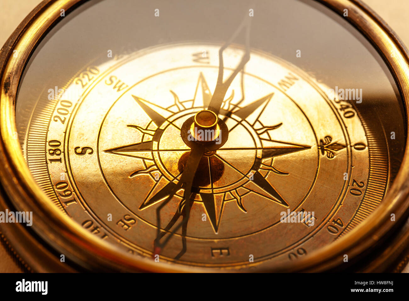 Vintage metal compass in toning light closeup Stock Photo - Alamy