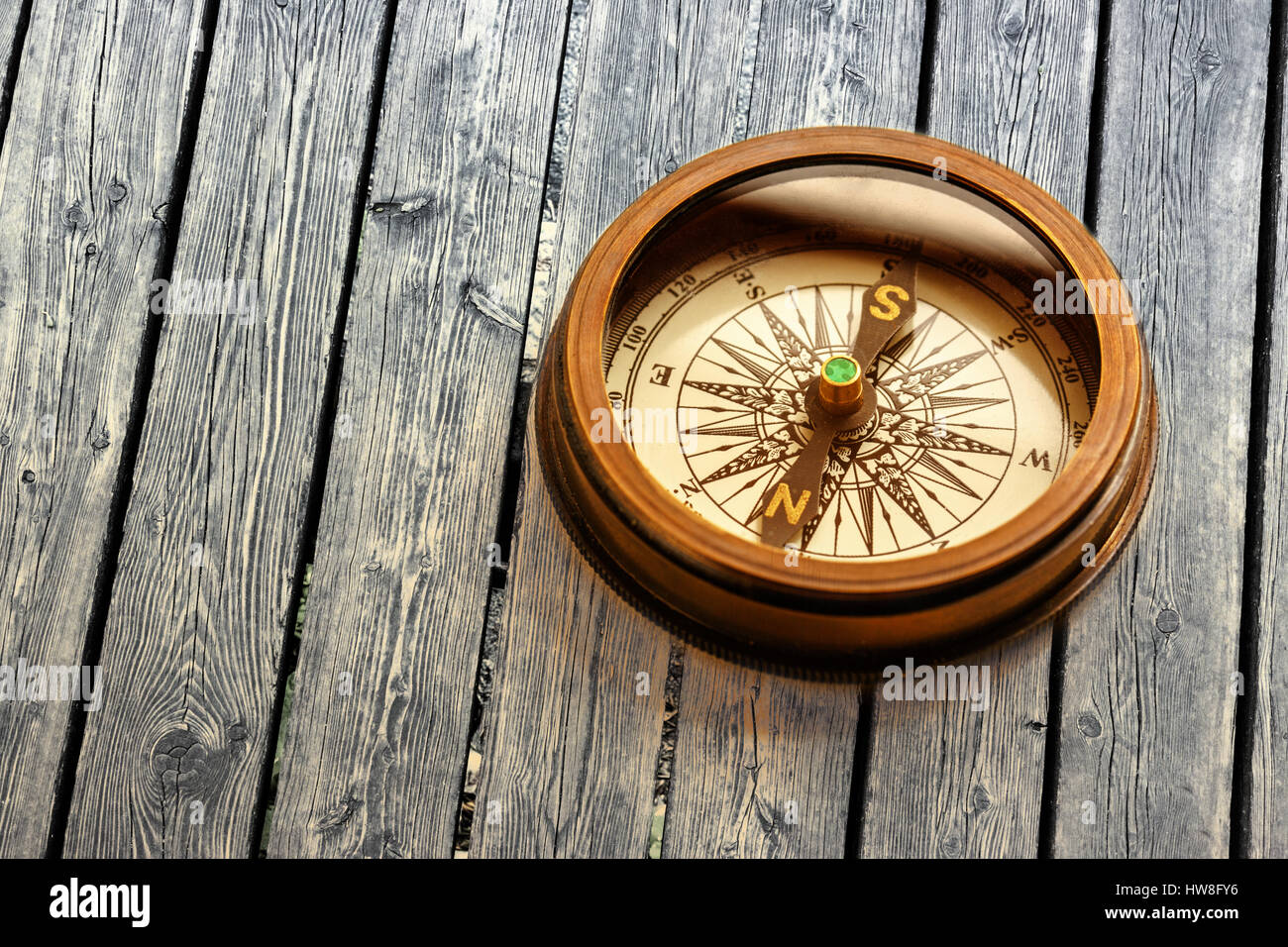 Vintage metal compass in toning light closeup Stock Photo - Alamy